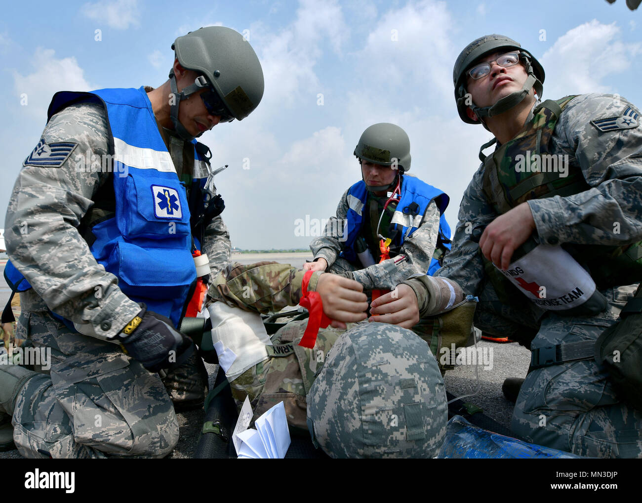 Members from the 51st Medical Group Field Response Team, strap a U.S ...