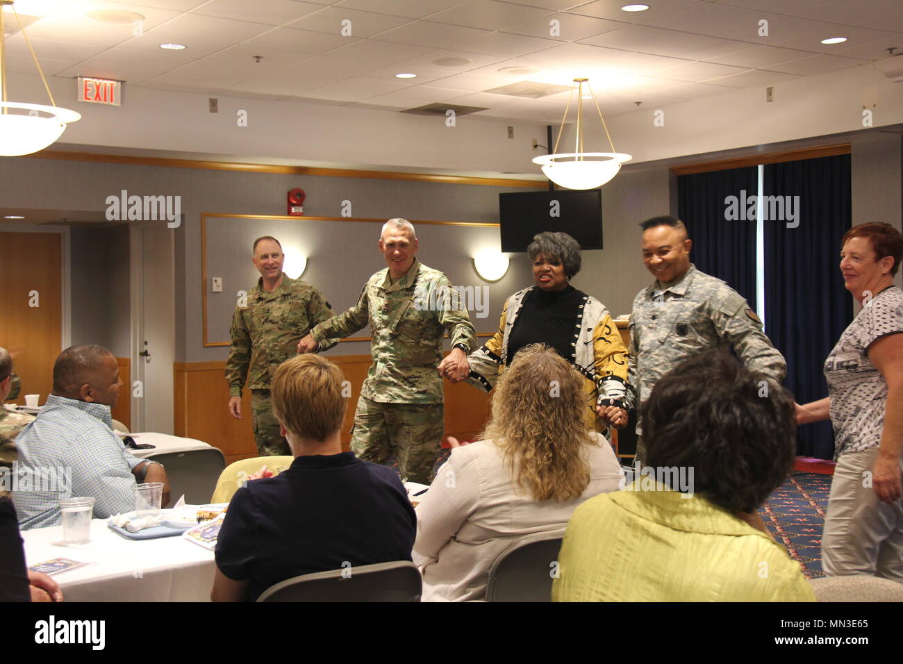 Guest speaker Hester J. Moore requests community members join her in a ...