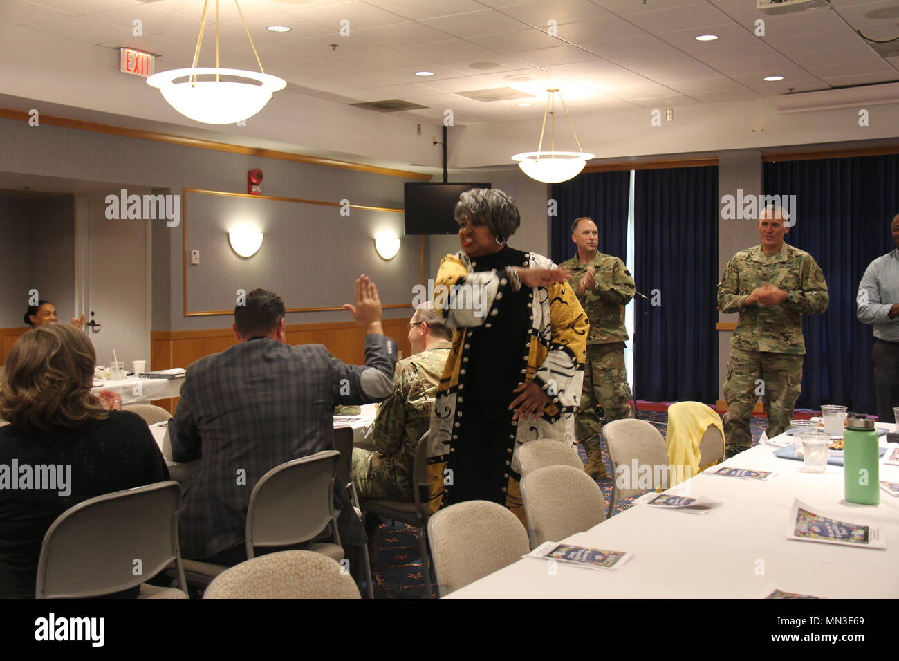 Guest speaker Hester J. Moore requests community members join her in a ...