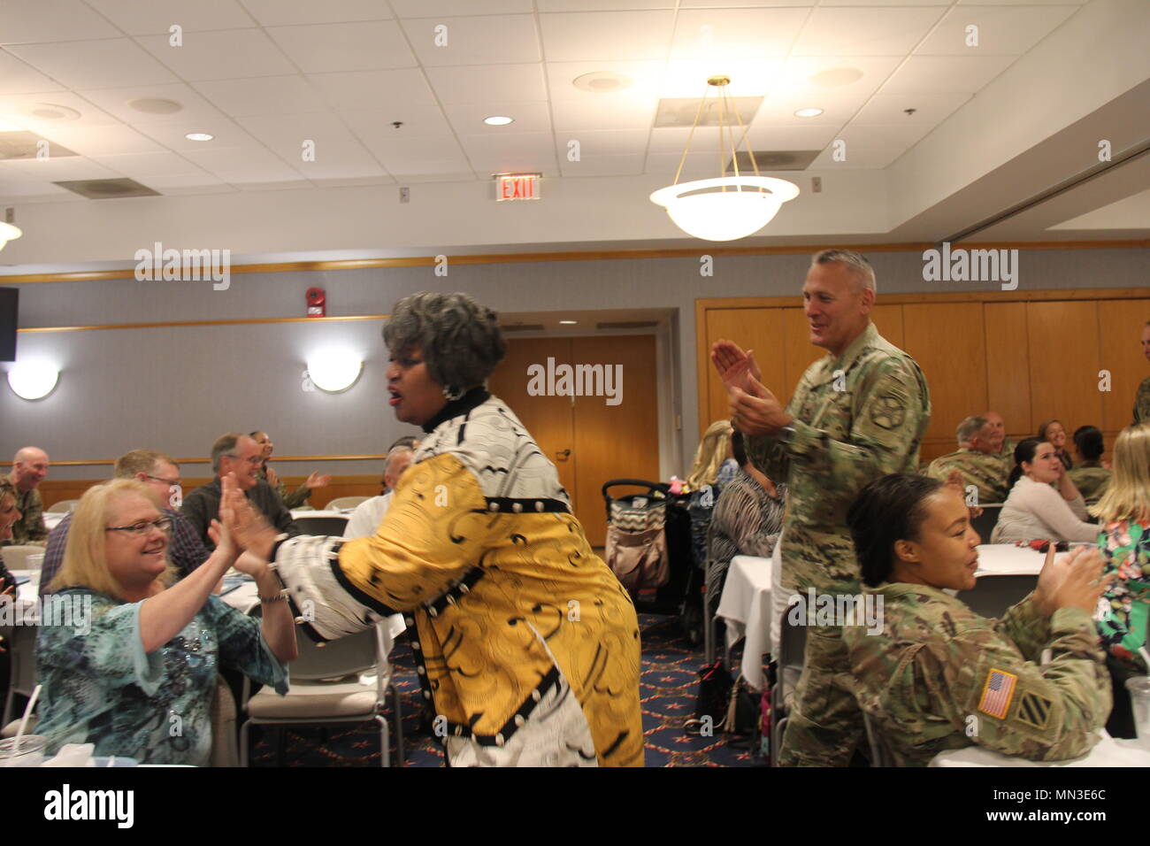 Guest speaker Hester J. Moore requests community members join her in a ...