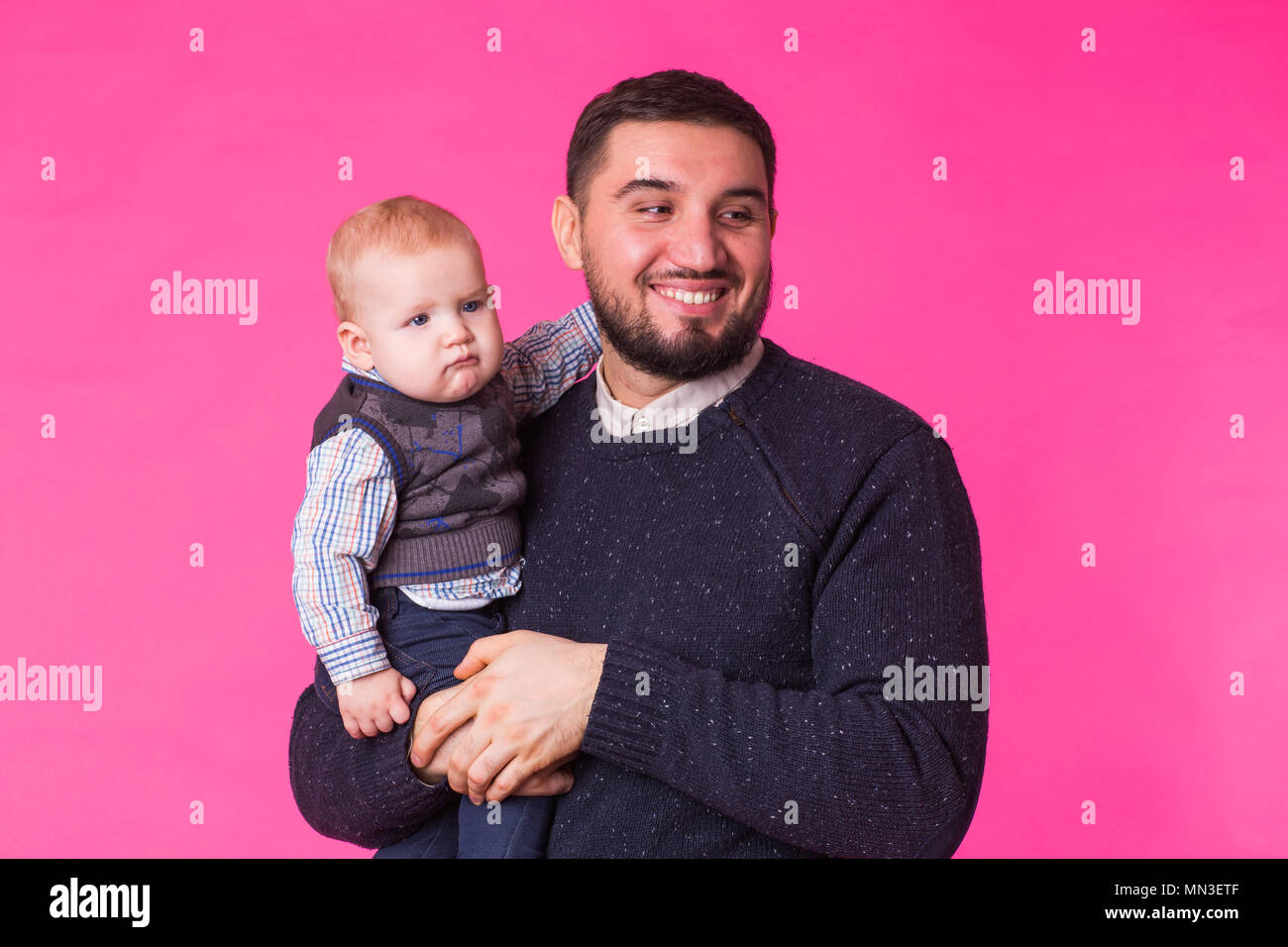 happy father with a baby son isolated on a pink background Stock Photo ...