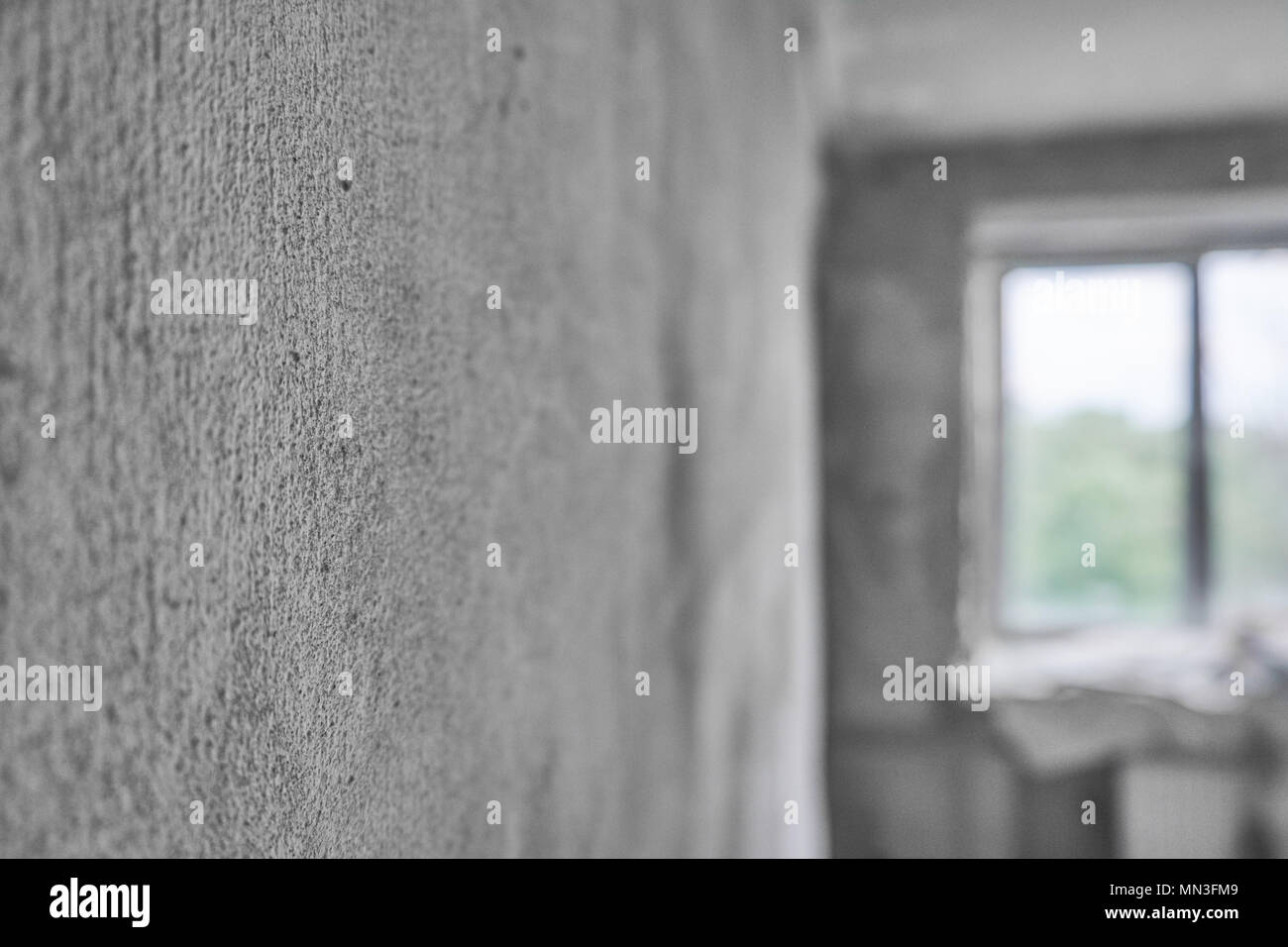 Concrete wall in front of a window. Overhaul concept. Apartment repairs ...