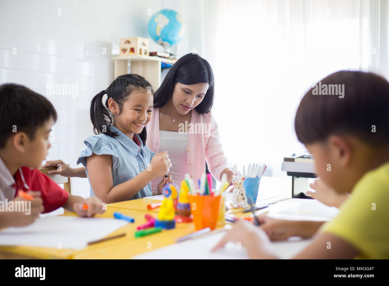 Asian students and woman teacher teach and learning art & painting at ...