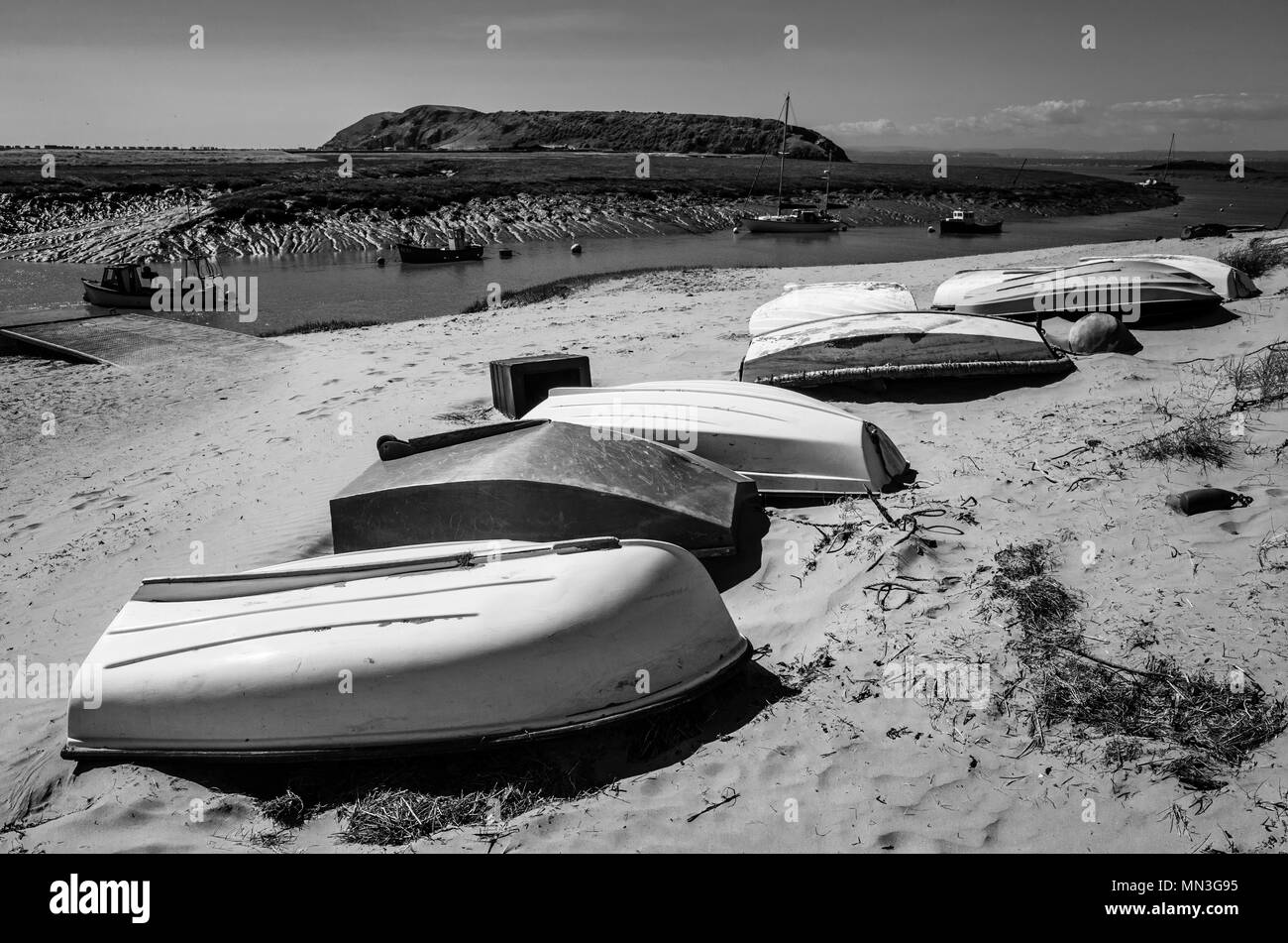 Monochrome picture of upturned rowing boats on the beach at Uphill ...