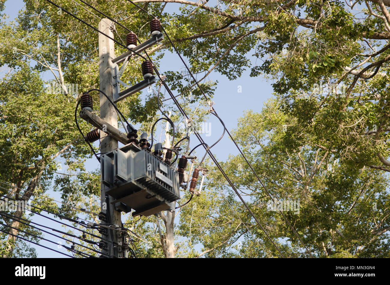 High voltage electric transformer in a power substation above the tower ...