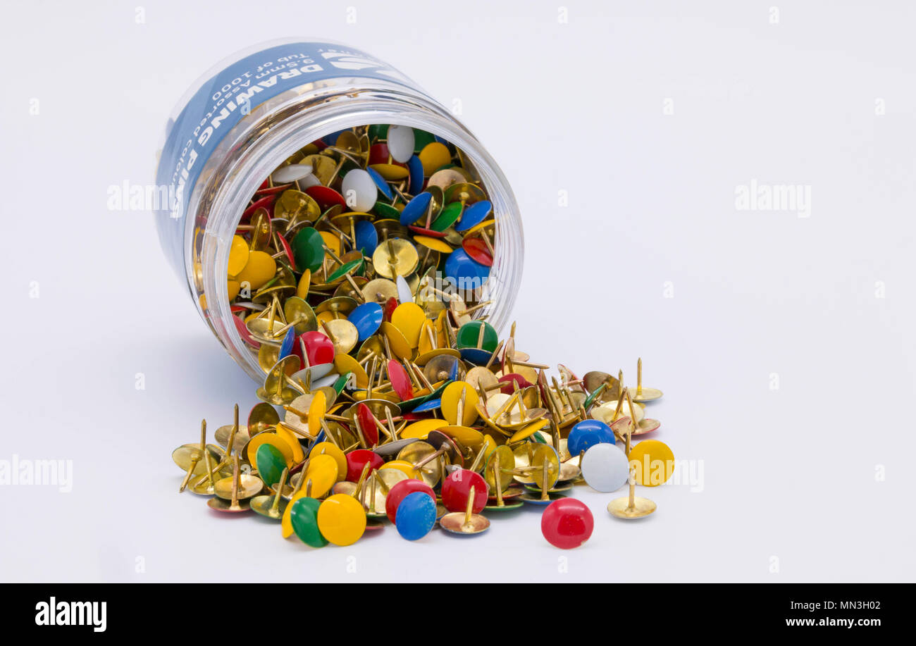 Pile of colourful drawing pins / thumb tacks on a white background ...