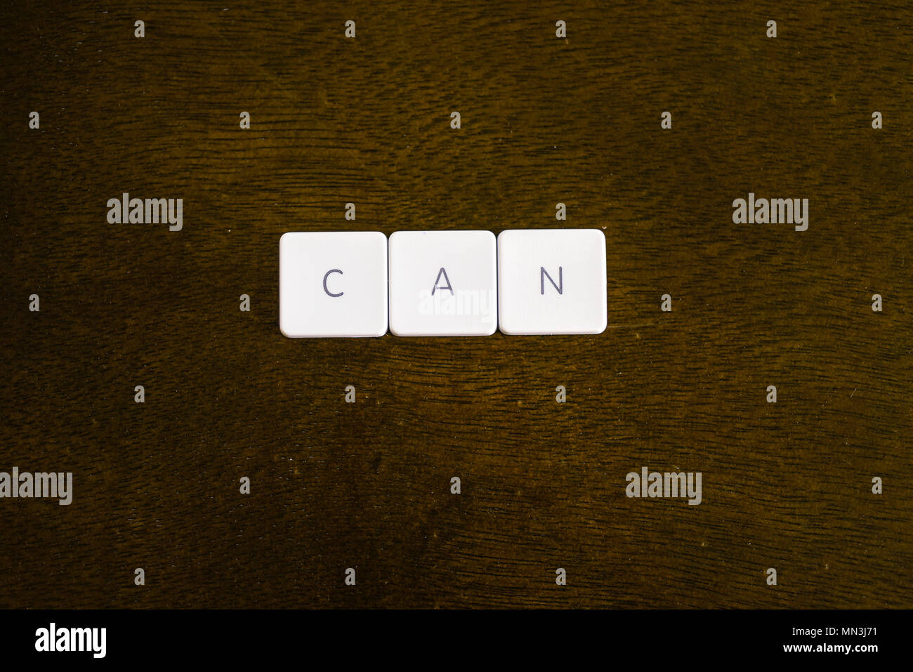CAN word written on plastic keyboard alphabet with dark background ...