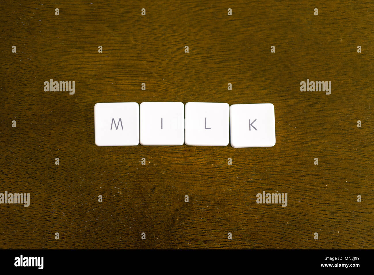 MILK word written on plastic keyboard alphabet with dark background ...
