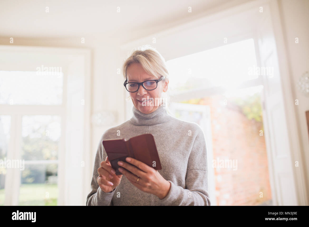 Mature woman reading diary Stock Photo - Alamy