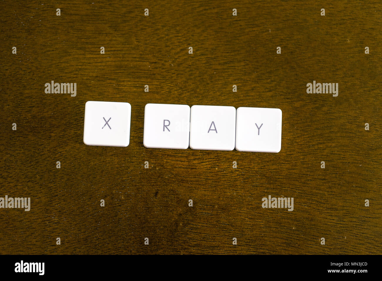 X RAY word written on plastic keyboard alphabet with dark background ...