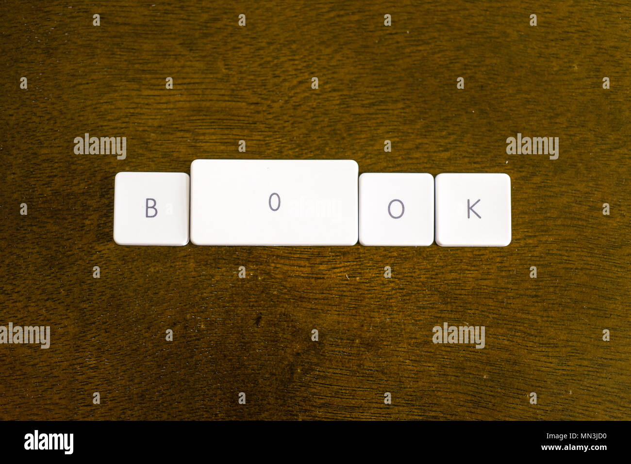 BOOK word written on plastic keyboard alphabet with dark background ...