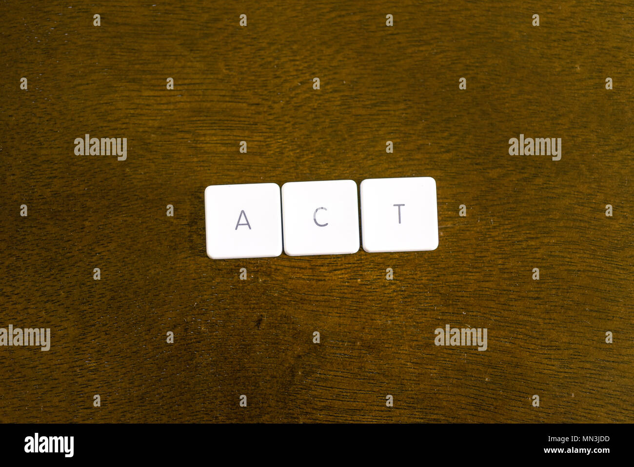 ACT word written on plastic keyboard alphabet with dark background ...