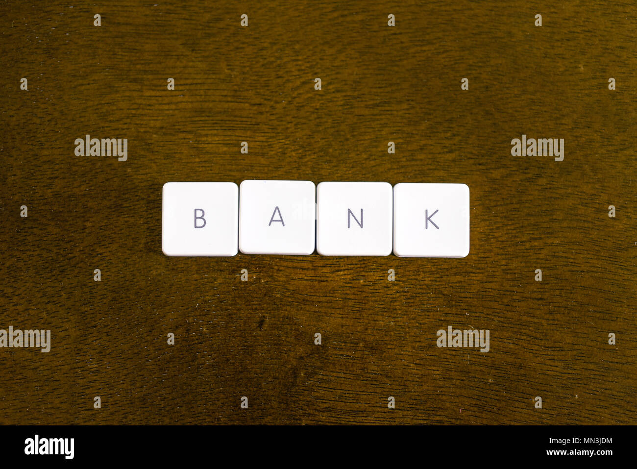 BANK word written on plastic keyboard alphabet with dark background ...