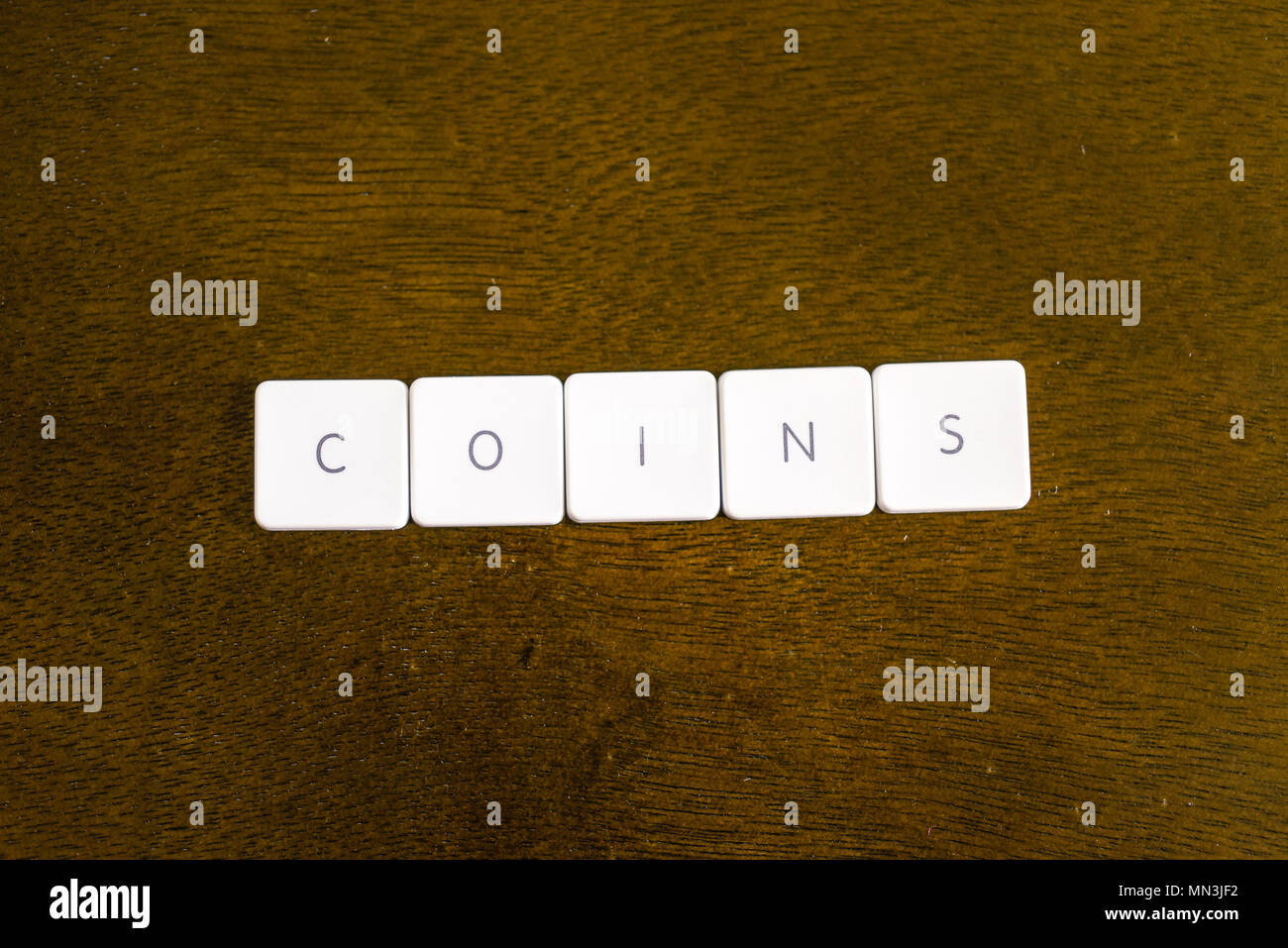 COINS word written on plastic keyboard alphabet with dark background ...