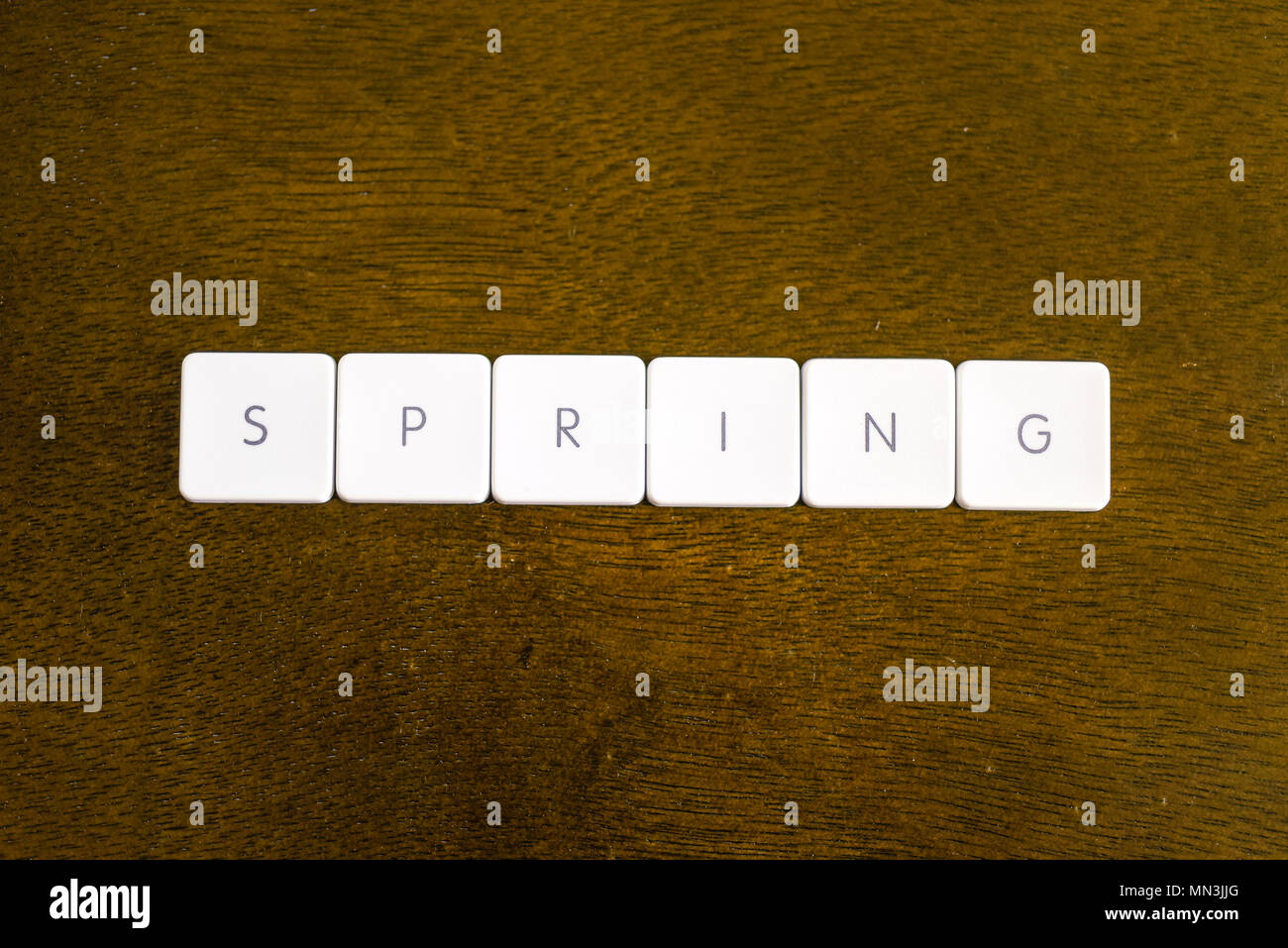 SPRING word written on plastic keyboard alphabet with dark background ...