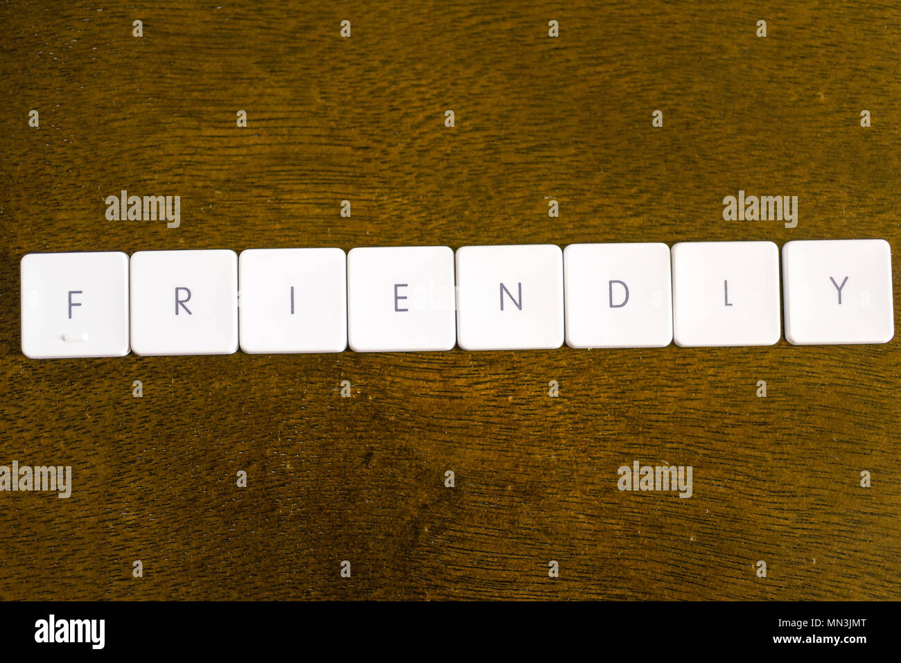 FRIENDLY word written on plastic keyboard alphabet with dark background ...