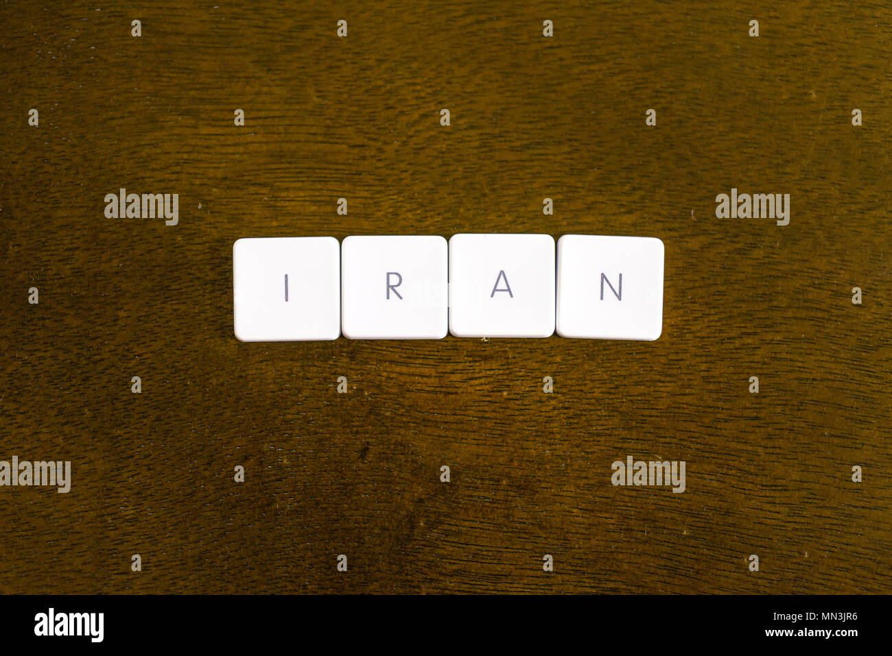 IRAN word written on plastic keyboard alphabet with dark background ...