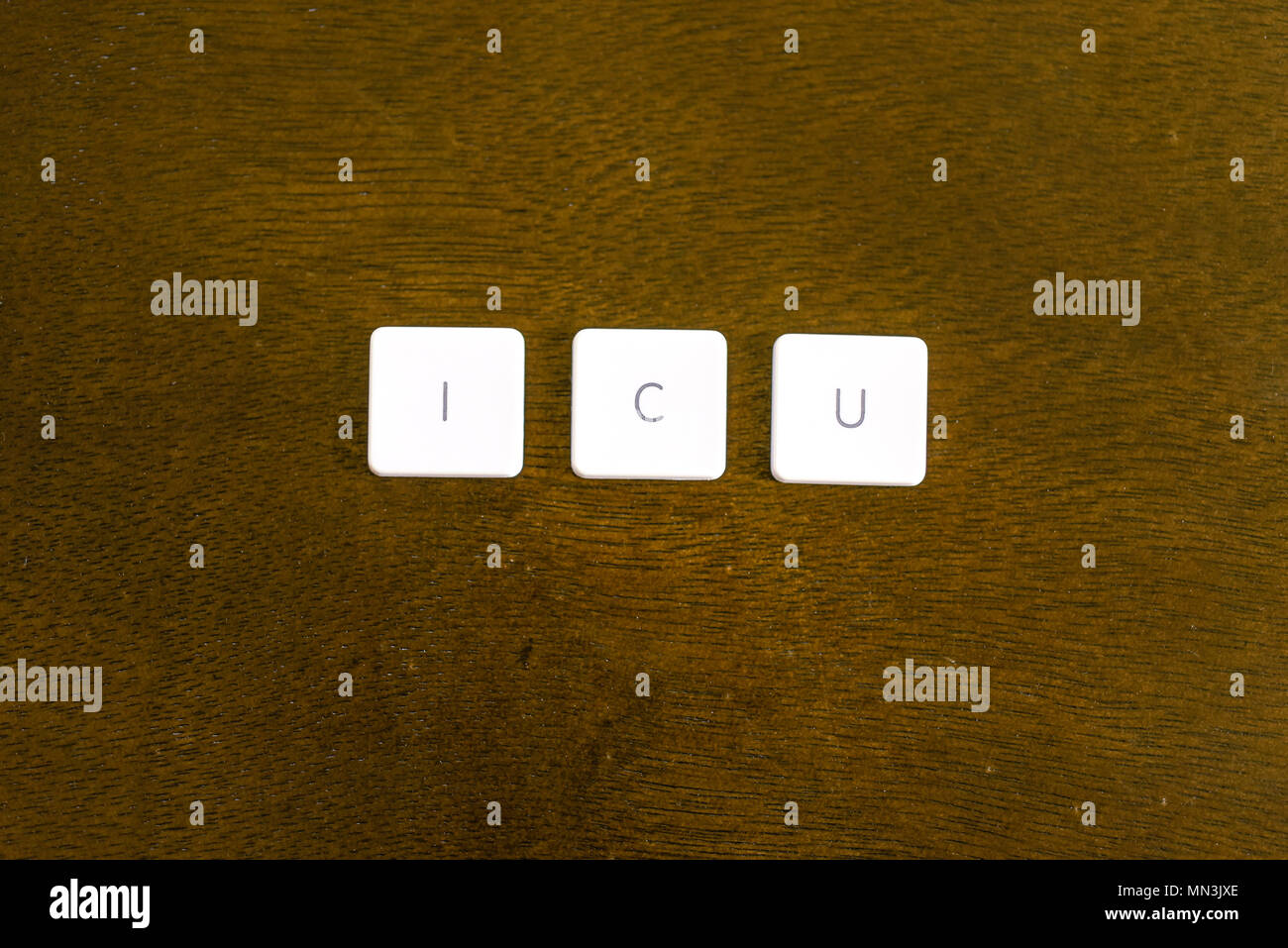 I.C.U. word written on plastic keyboard alphabet with dark background ...