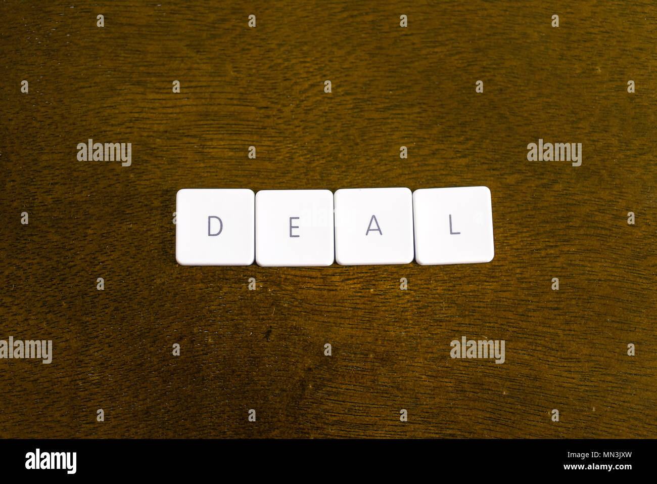 DEAL word written on plastic keyboard alphabet with dark background ...