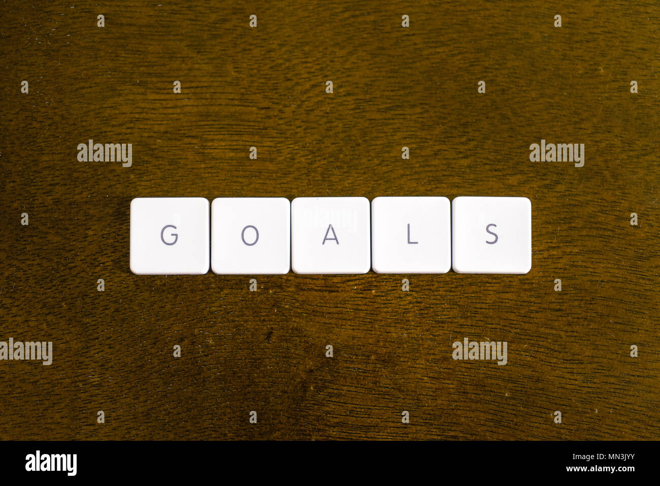 GOALS word written on plastic keyboard alphabet with dark background ...