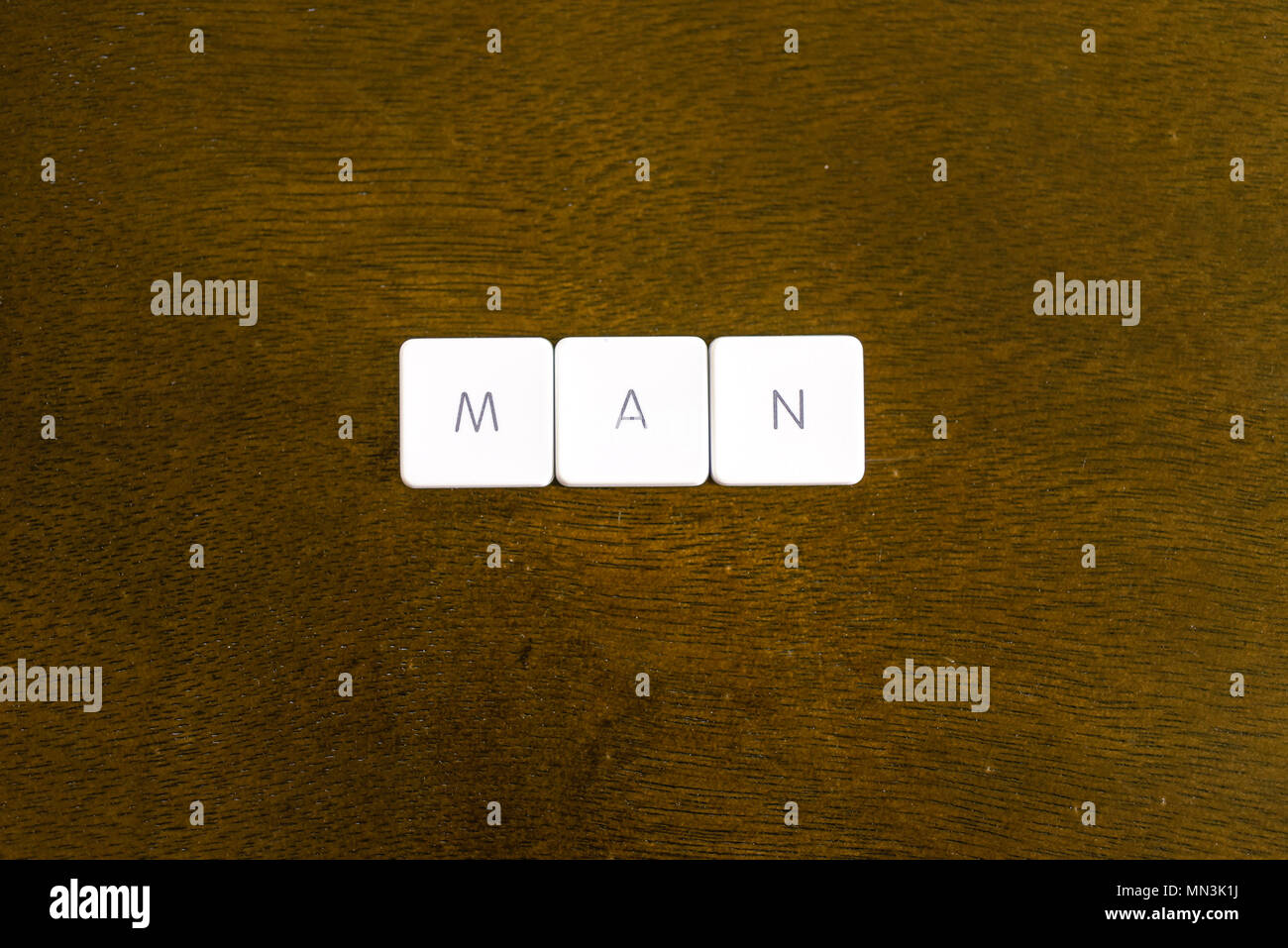 MAN word written on plastic keyboard alphabet with dark background ...
