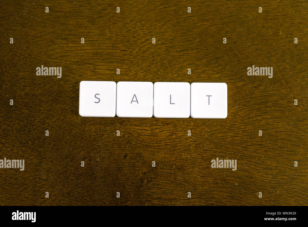 SALT word written on plastic keyboard alphabet with dark background ...