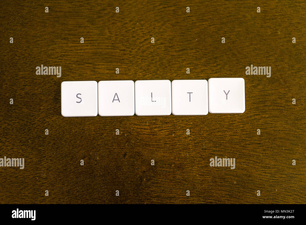 SALTY word written on plastic keyboard alphabet with dark background ...