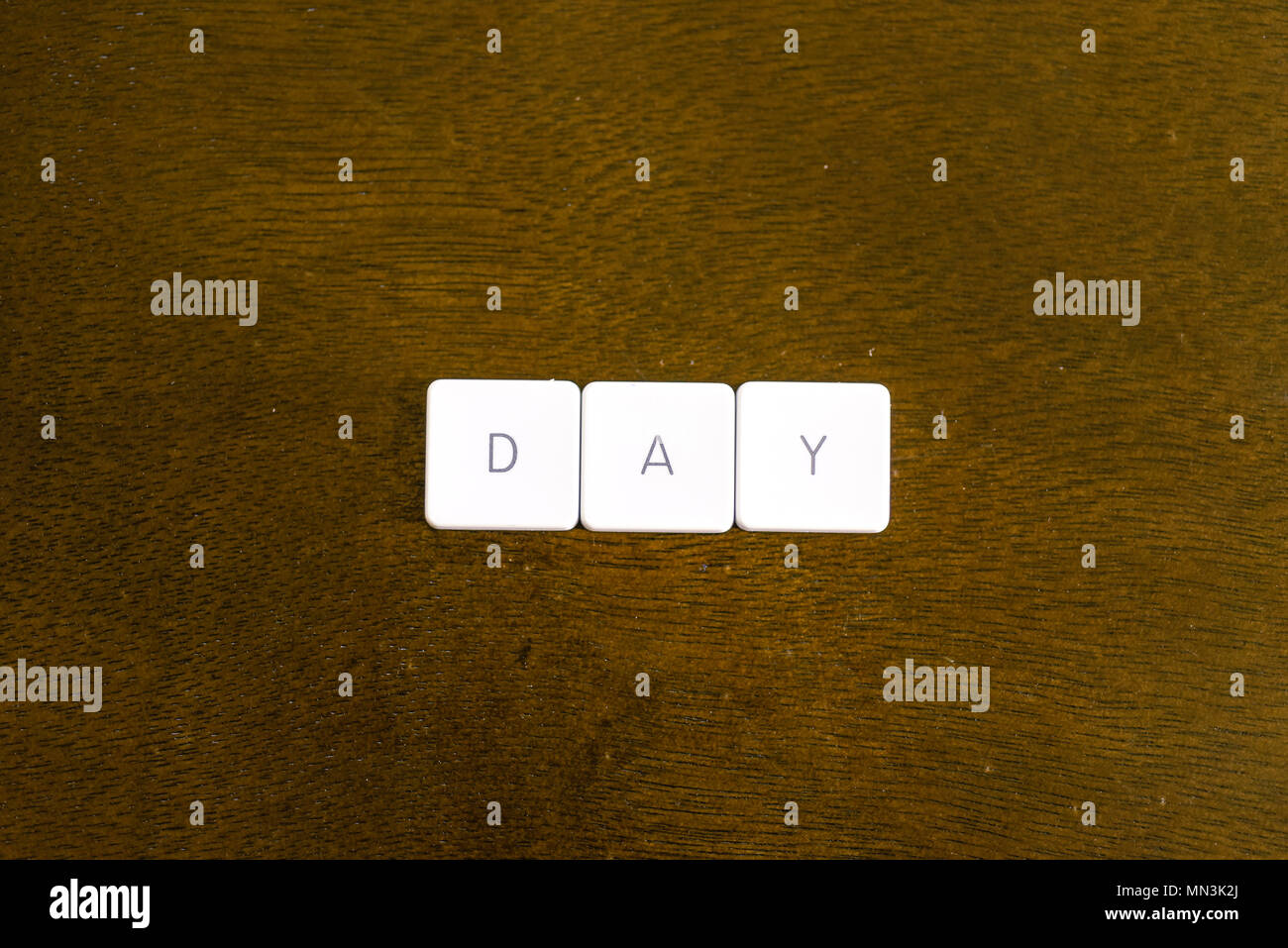DAY word written on plastic keyboard alphabet with dark background ...