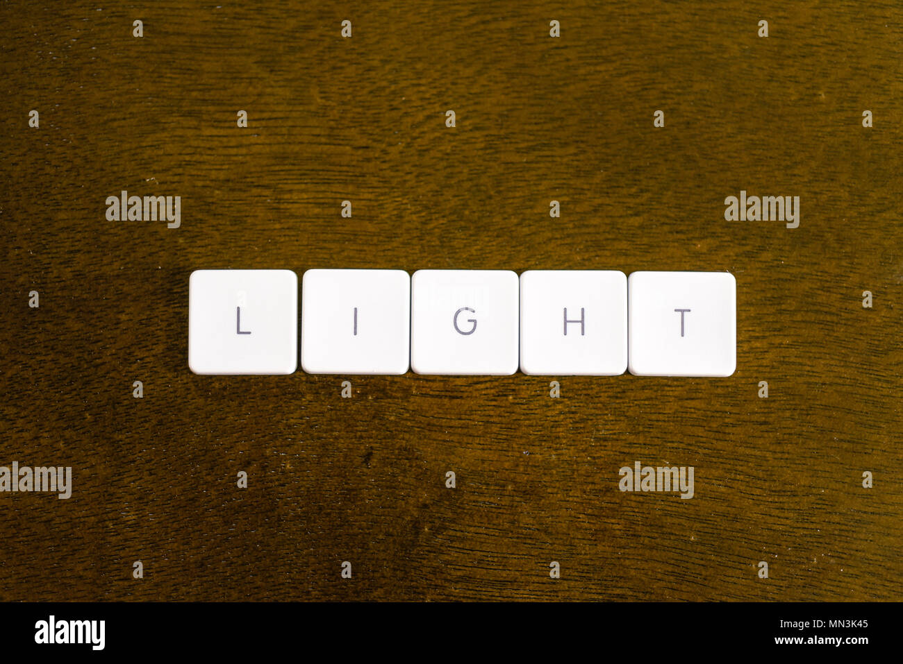 LIGHT word written on plastic keyboard alphabet with dark background ...