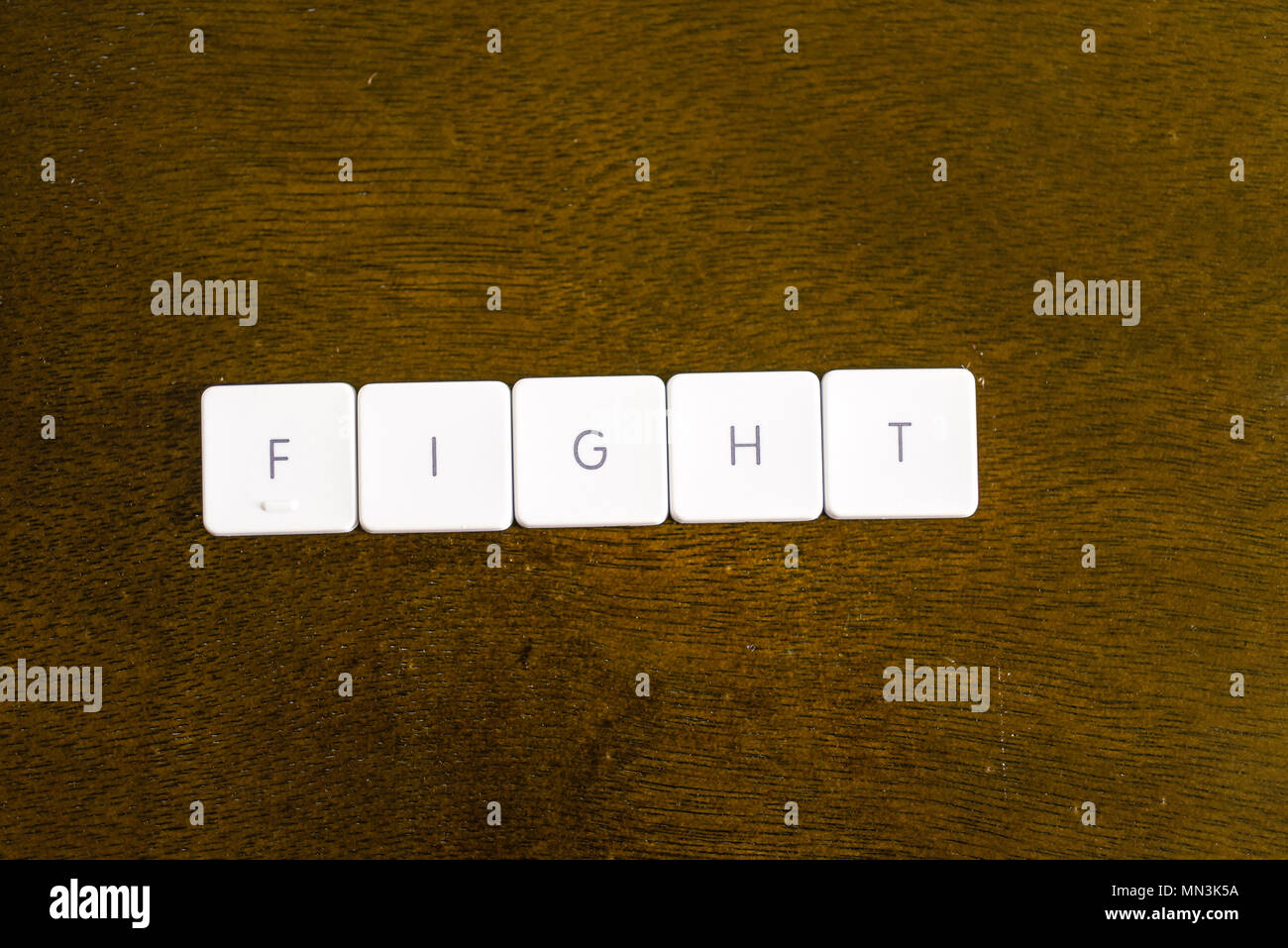 FIGHT word written on plastic keyboard alphabet with dark background ...