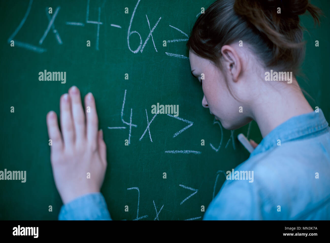 Teenager girl in math class overwhelmed by the math formula. Pressure ...