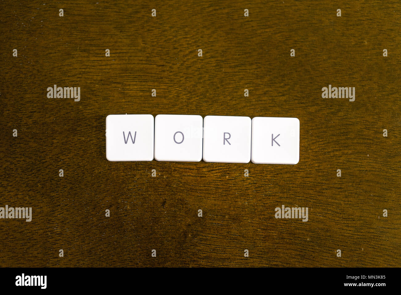 WORK word written on plastic keyboard alphabet with dark background ...