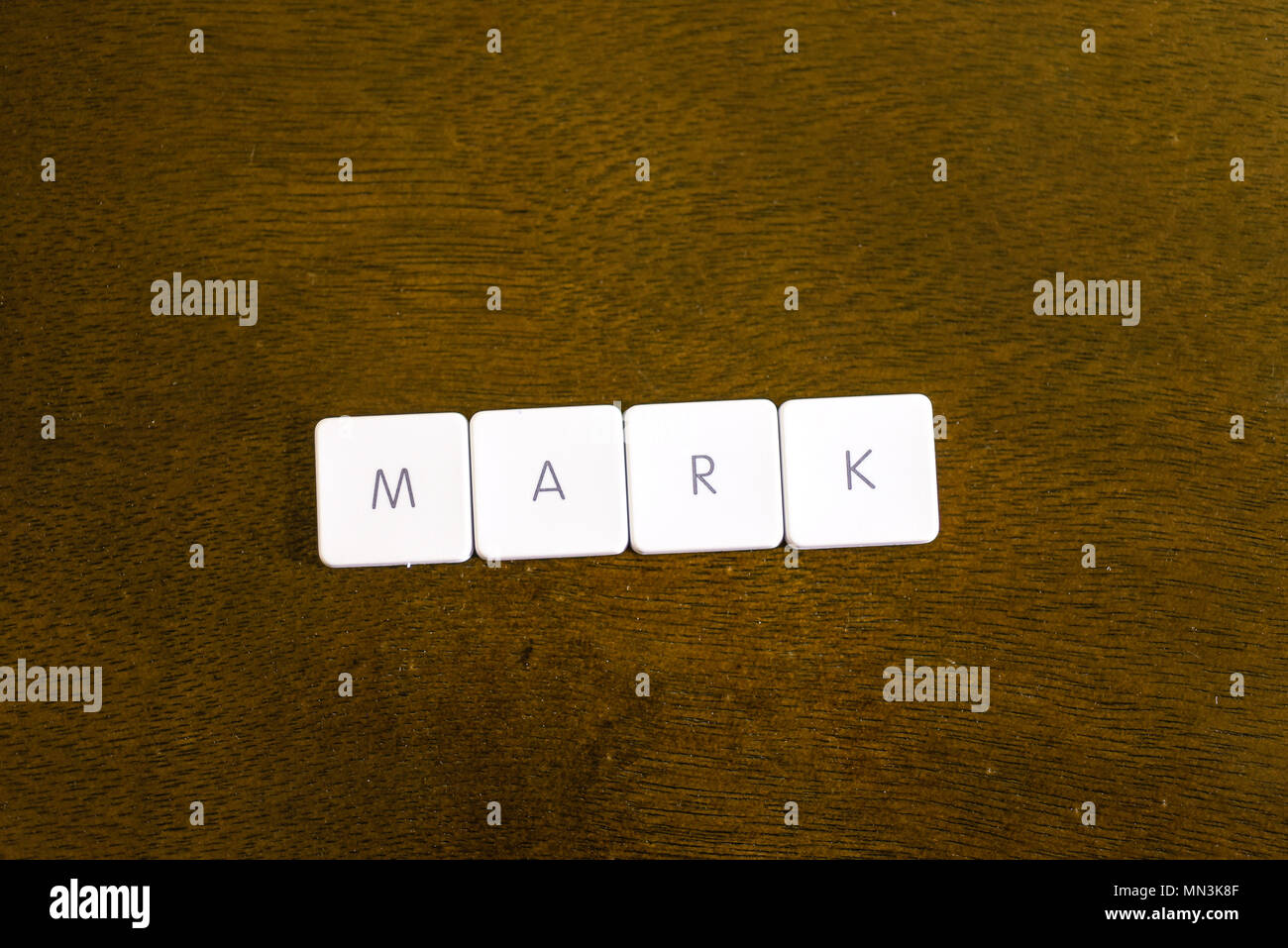 MARK word written on plastic keyboard alphabet with dark background ...