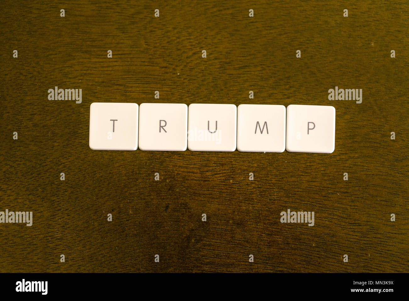 TRUMP word written on plastic keyboard alphabet with dark background ...