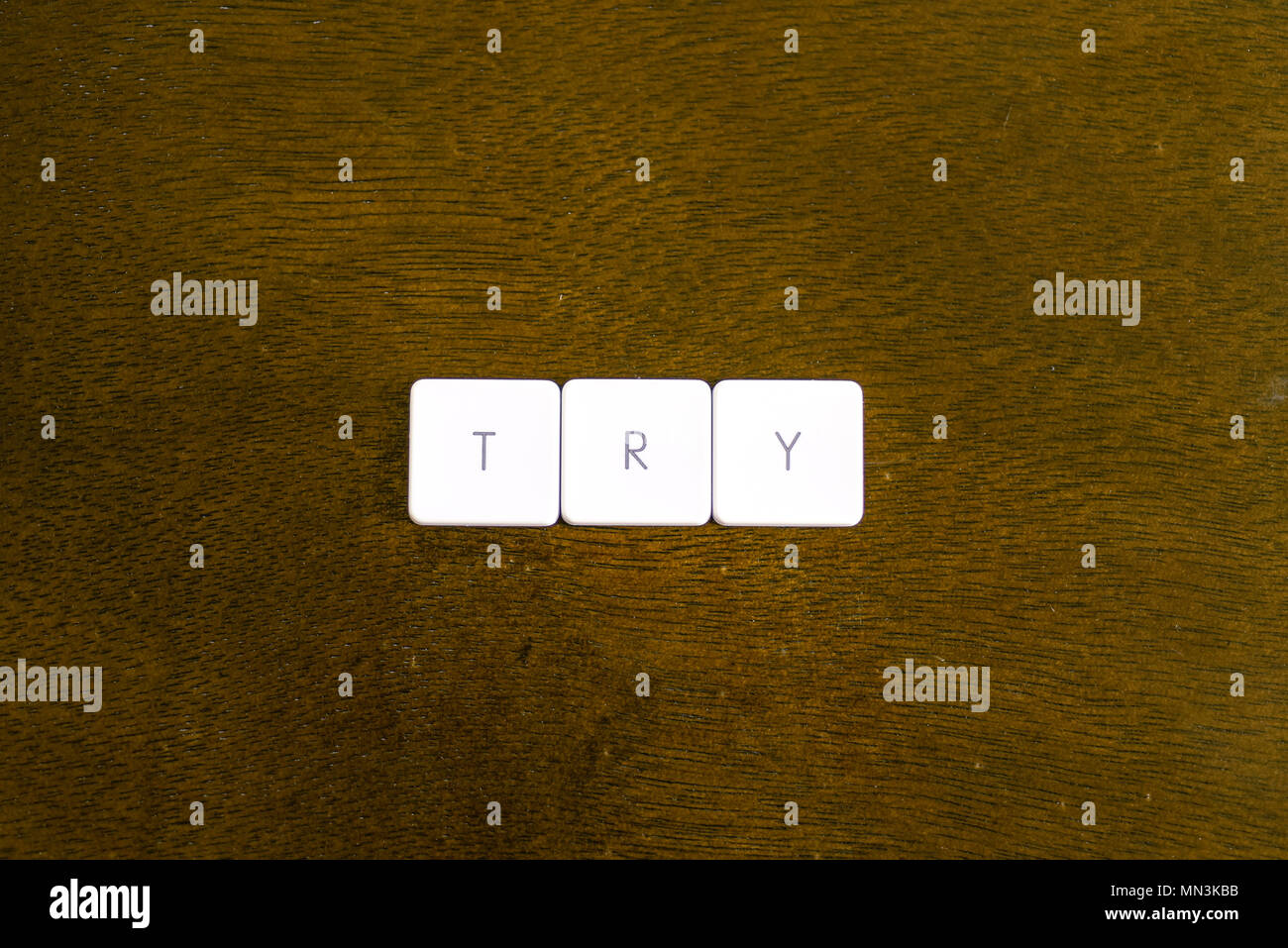 TRY word written on plastic keyboard alphabet with dark background ...
