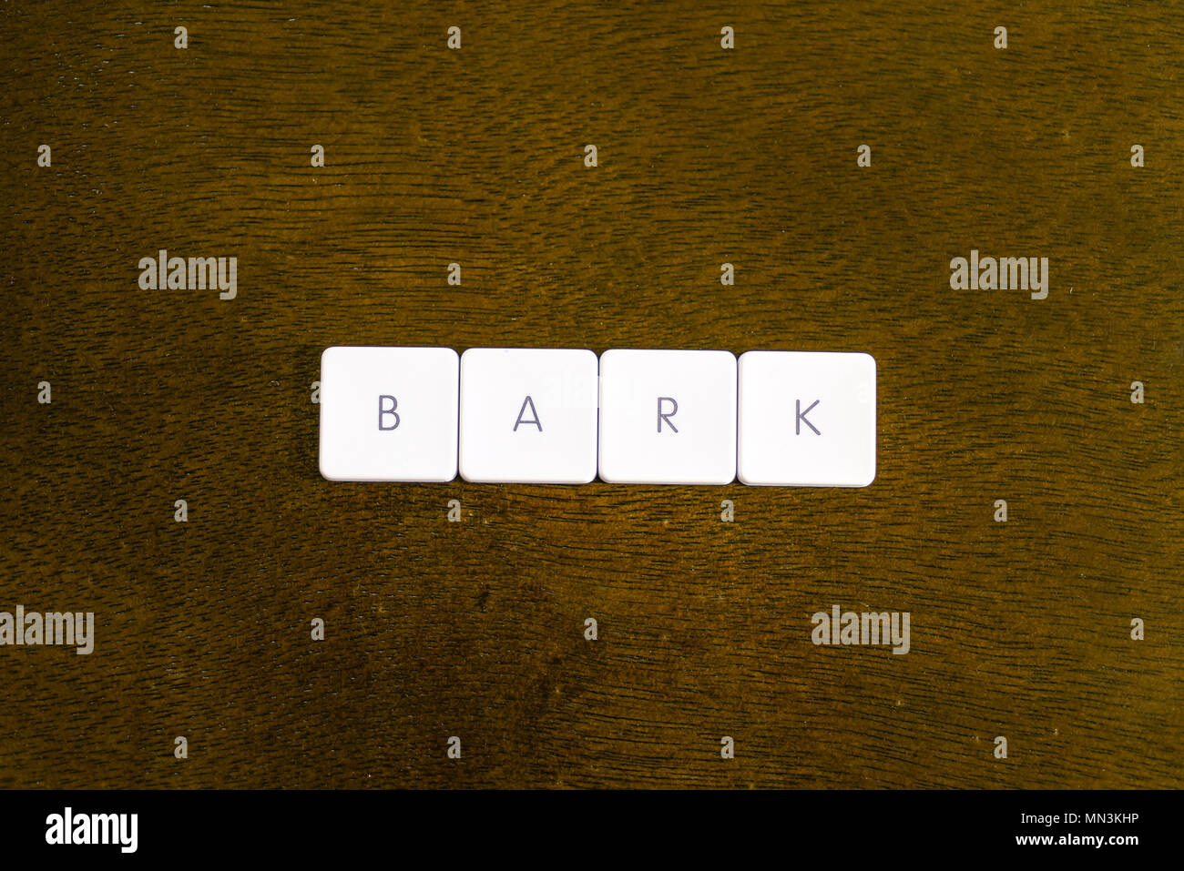 BARK word written on plastic keyboard alphabet with dark background ...
