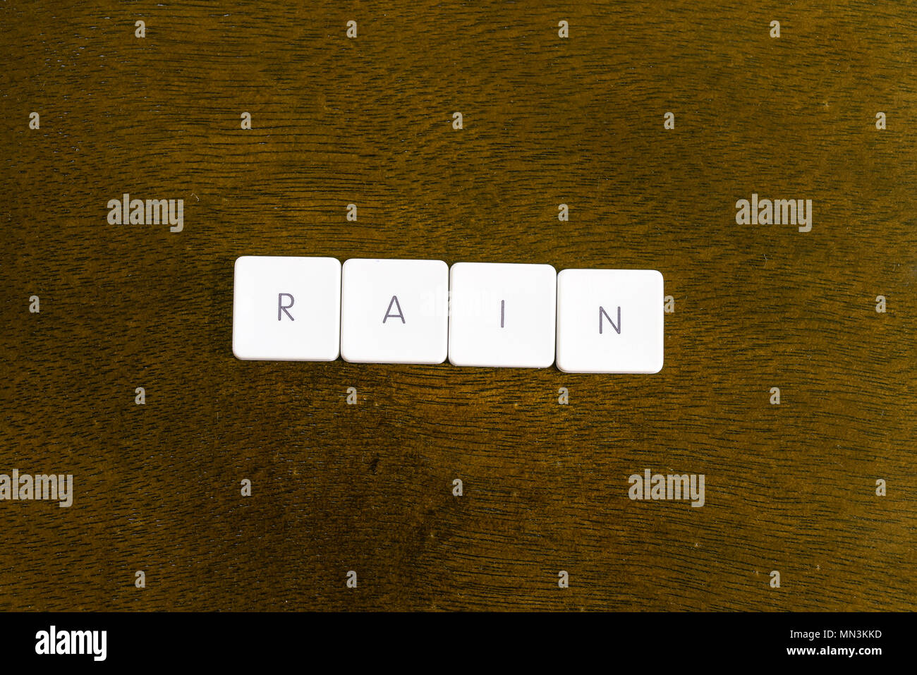 RAIN word written on plastic keyboard alphabet with dark background ...