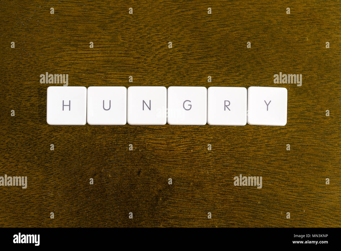 HUNGRY word written on plastic keyboard alphabet with dark background ...
