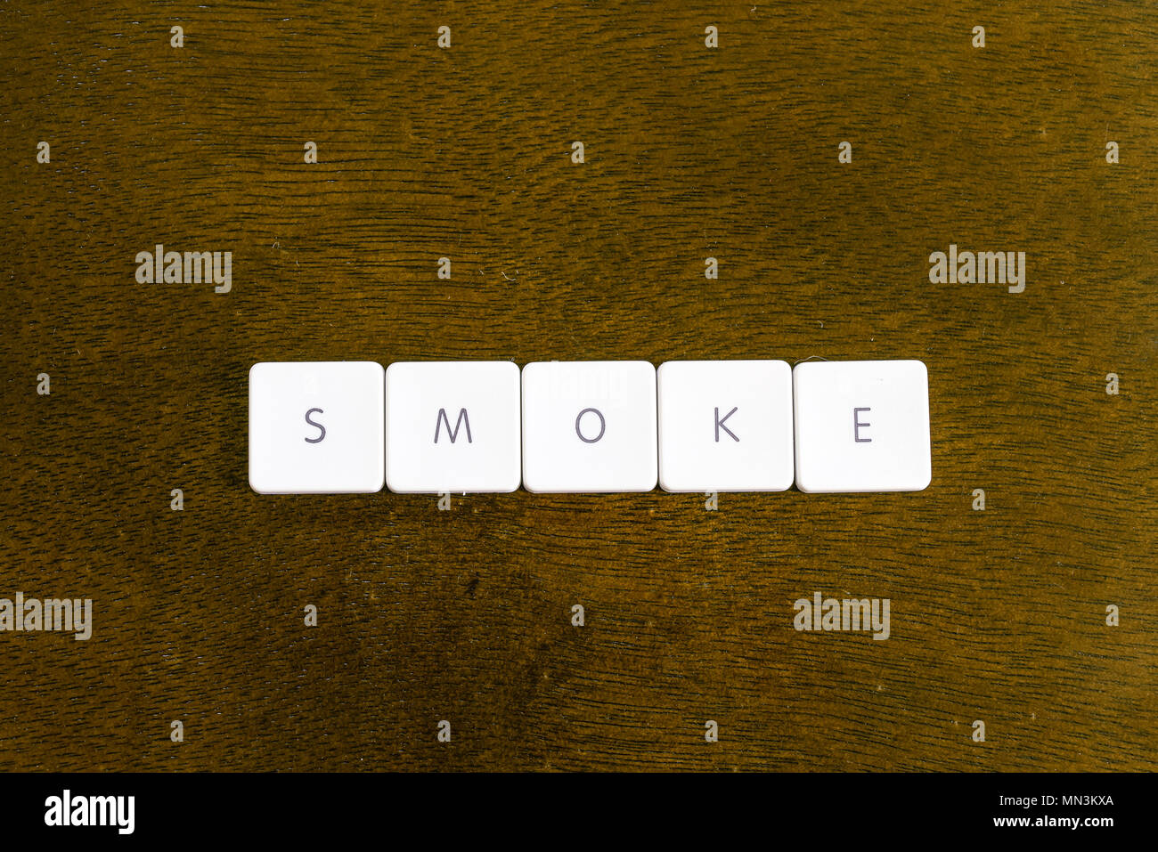 SMOKE word written on plastic keyboard alphabet with dark background ...