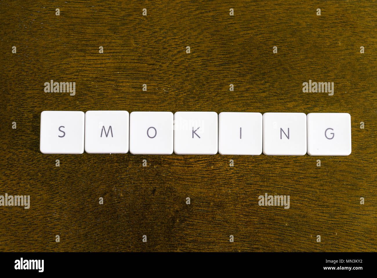 SMOKING word written on plastic keyboard alphabet with dark background ...