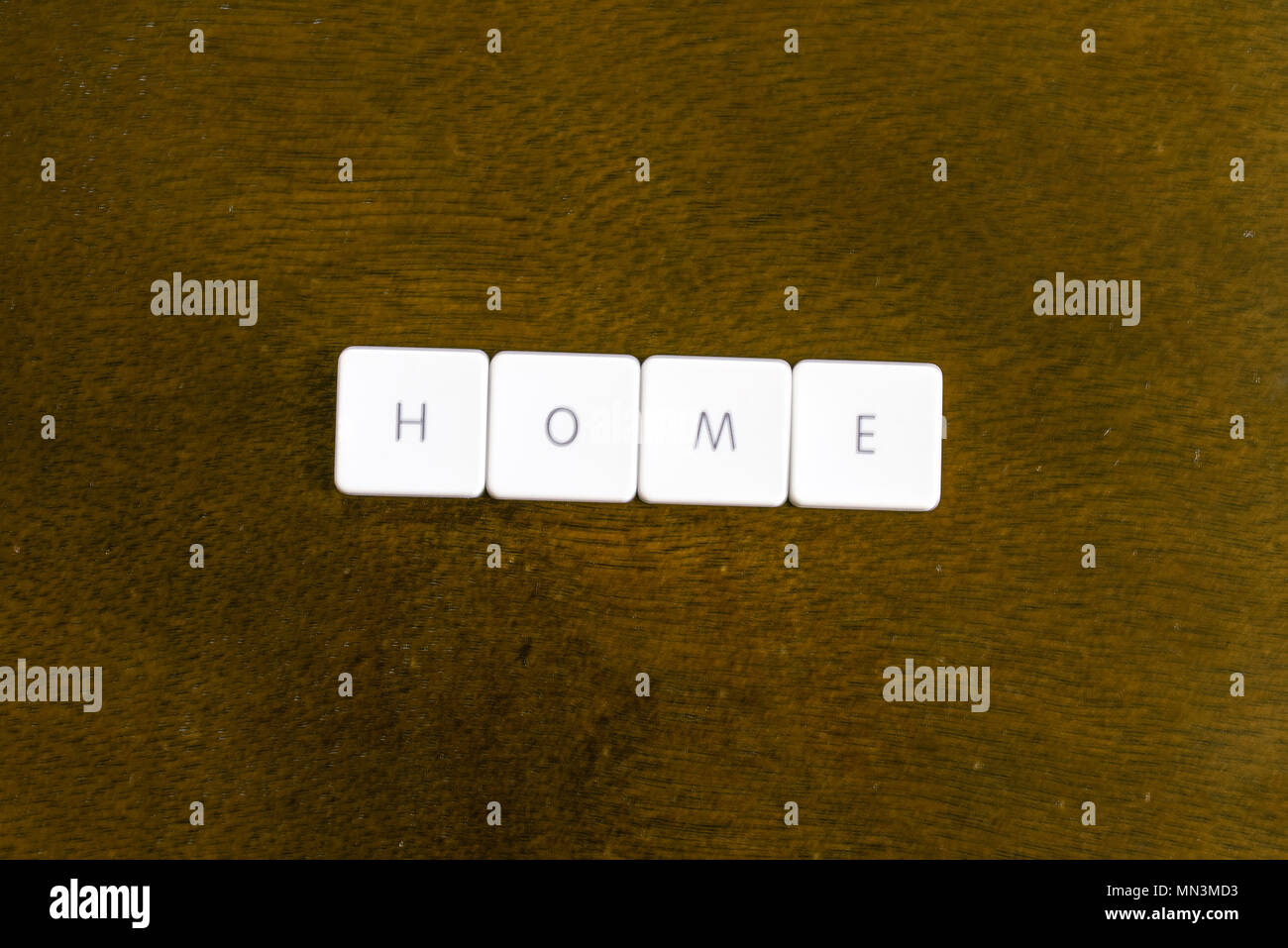 HOME word written on plastic keyboard alphabet with dark background ...
