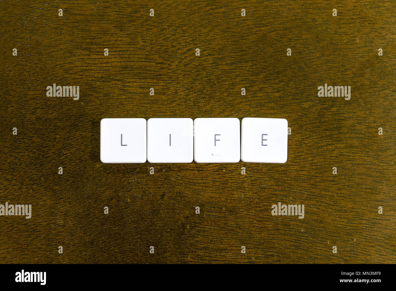LIFE word written on plastic keyboard alphabet with dark background ...