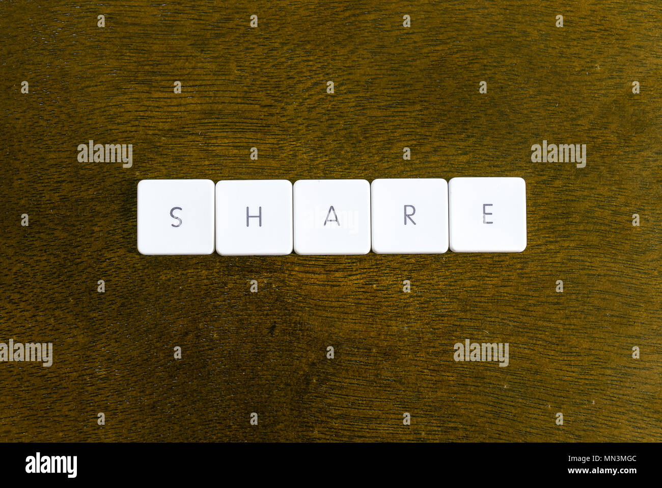 SHARE word written on plastic keyboard alphabet with dark background ...