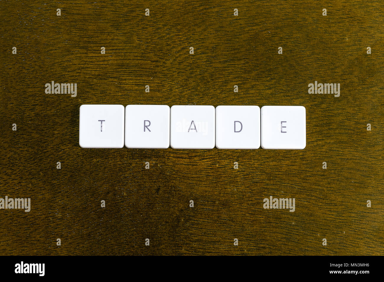 TRADE word written on plastic keyboard alphabet with dark background ...