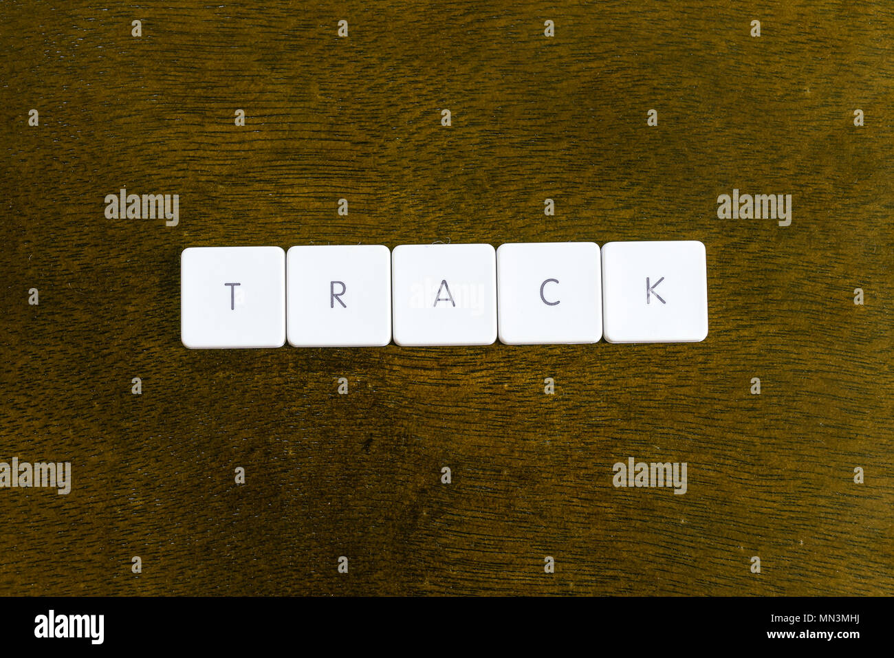 TRACK word written on plastic keyboard alphabet with dark background ...