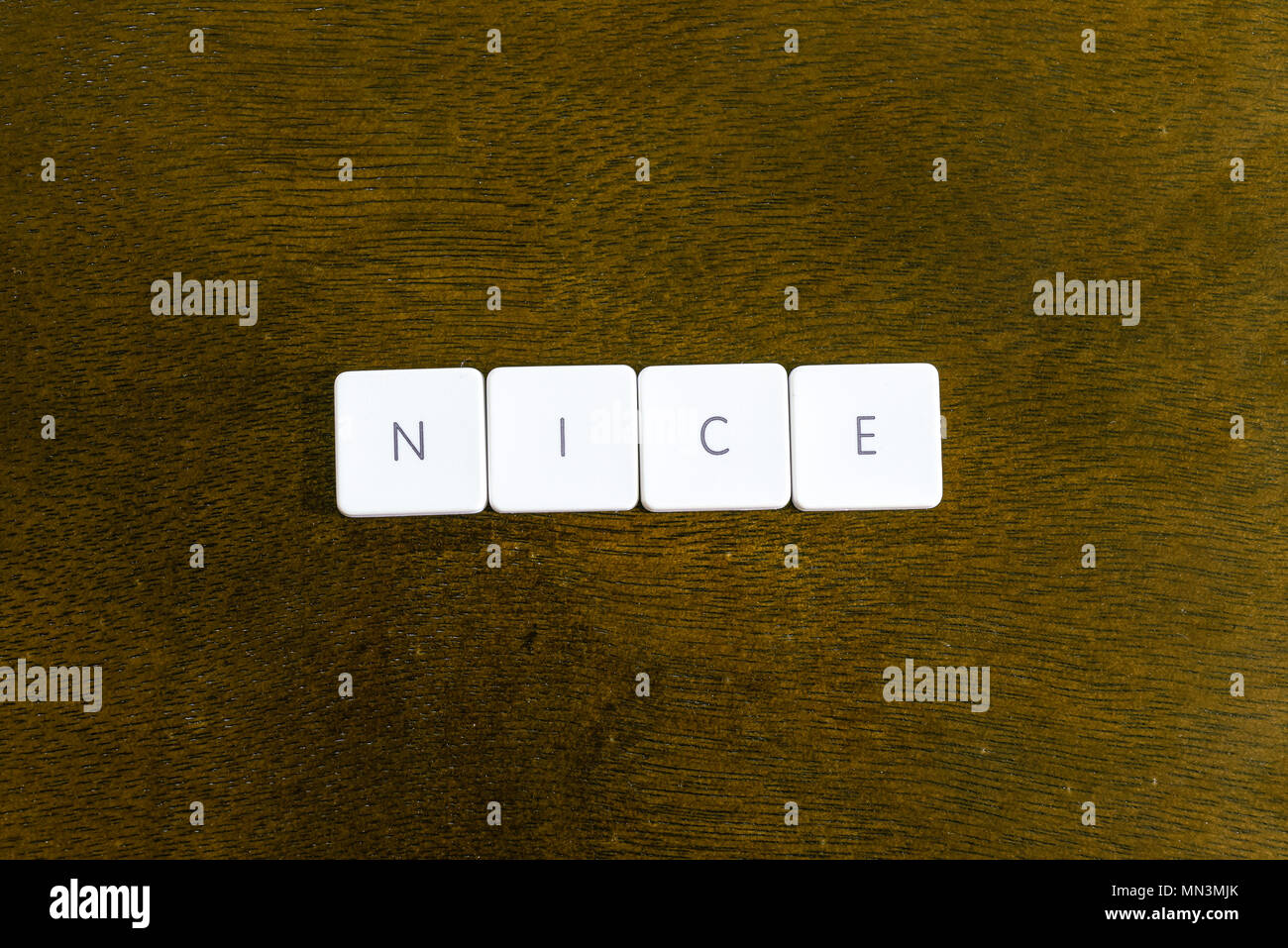 NICE word written on plastic keyboard alphabet with dark background ...