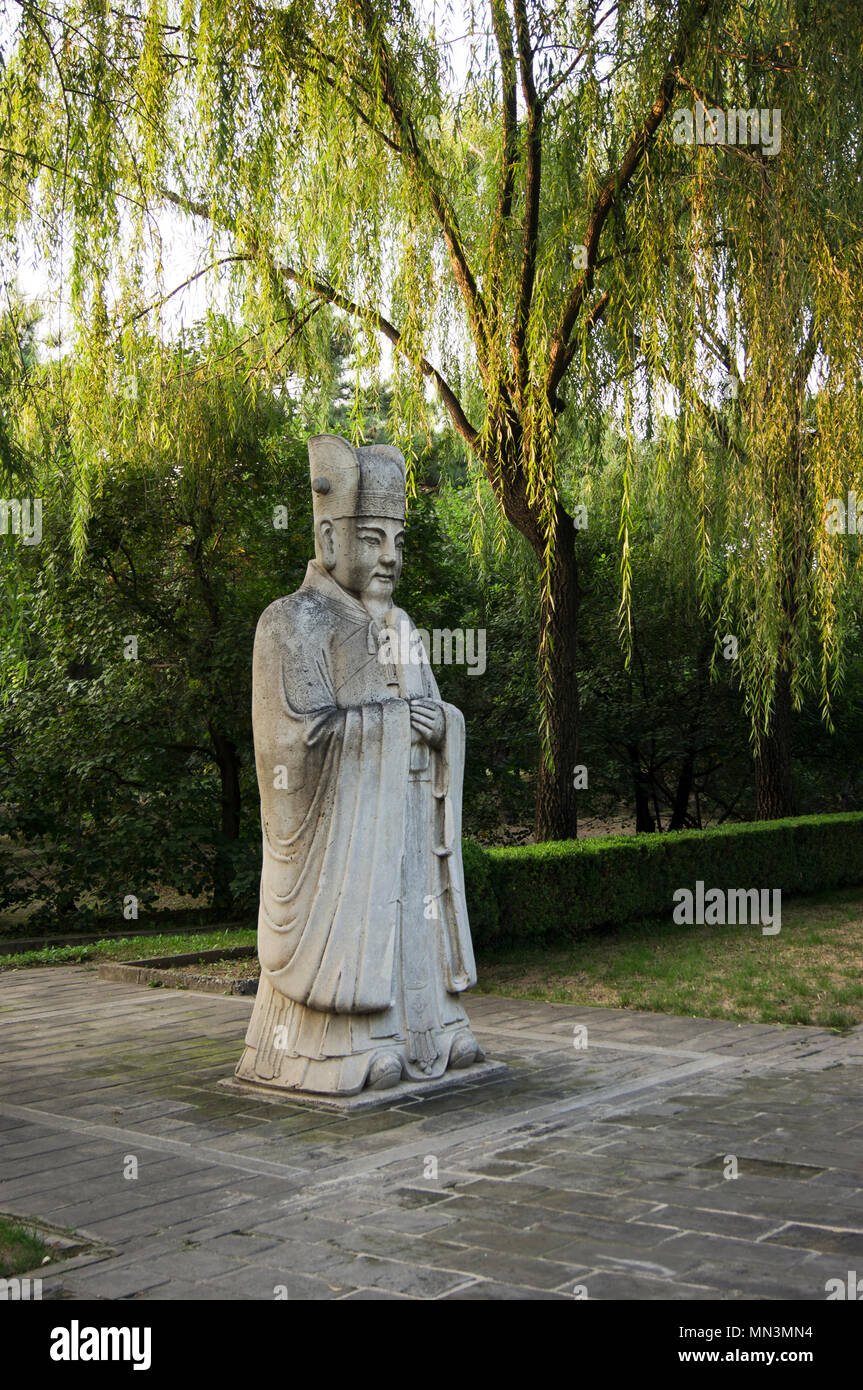 An ornate stone-carved Chinese priest statue in a park near the Ming ...