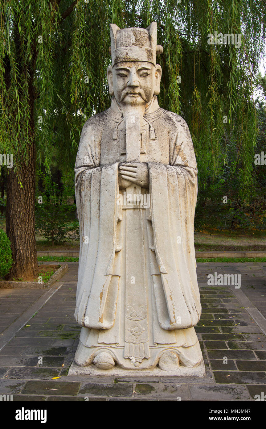 An ornate stone-carved Chinese priest statue in a park near the Ming ...