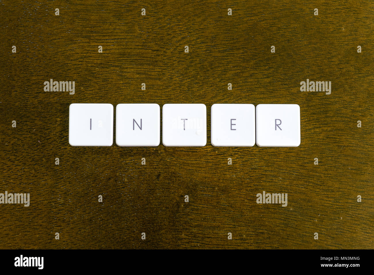 INTER word written on plastic keyboard alphabet with dark background ...