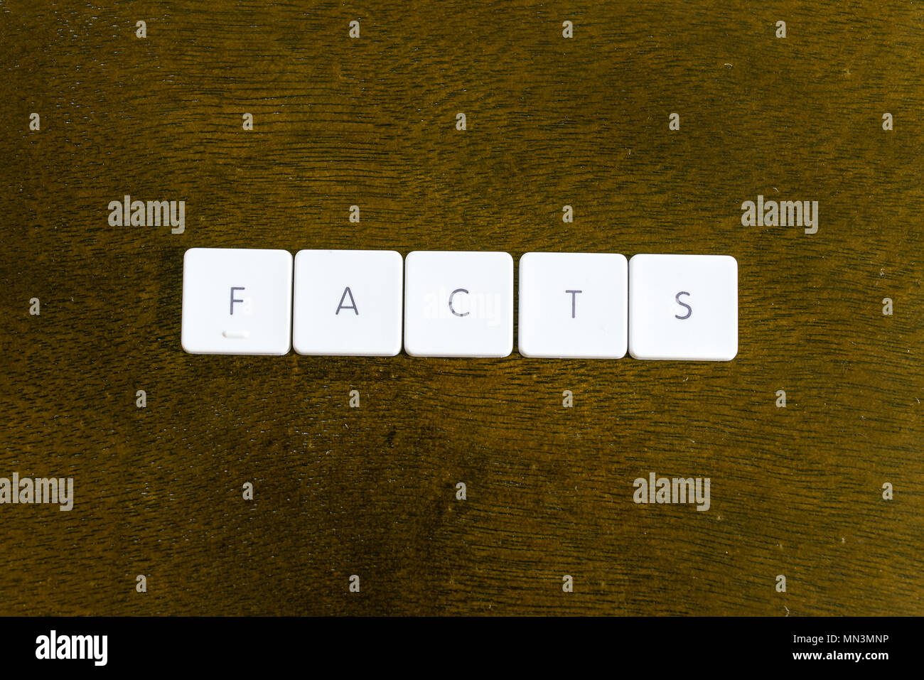 FACTS word written on plastic keyboard alphabet with dark background ...